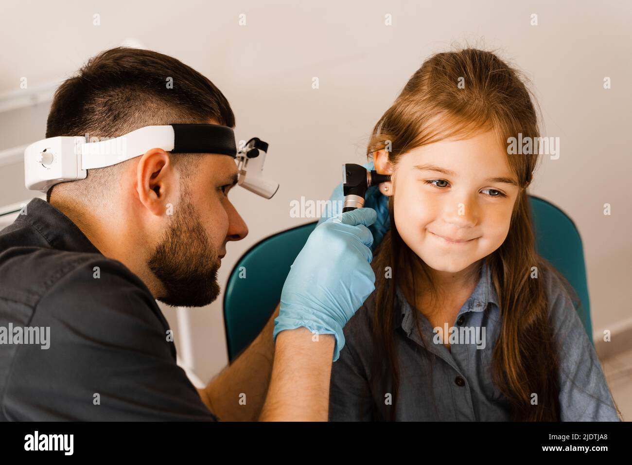 Otoscopy of child ears with otoscope. ENT doctor. Consultation with ...