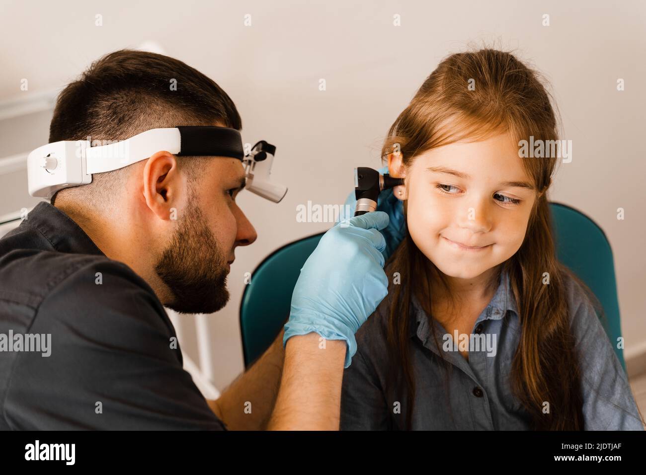 Otoscopy of child ears with otoscope. ENT doctor. Consultation with ...