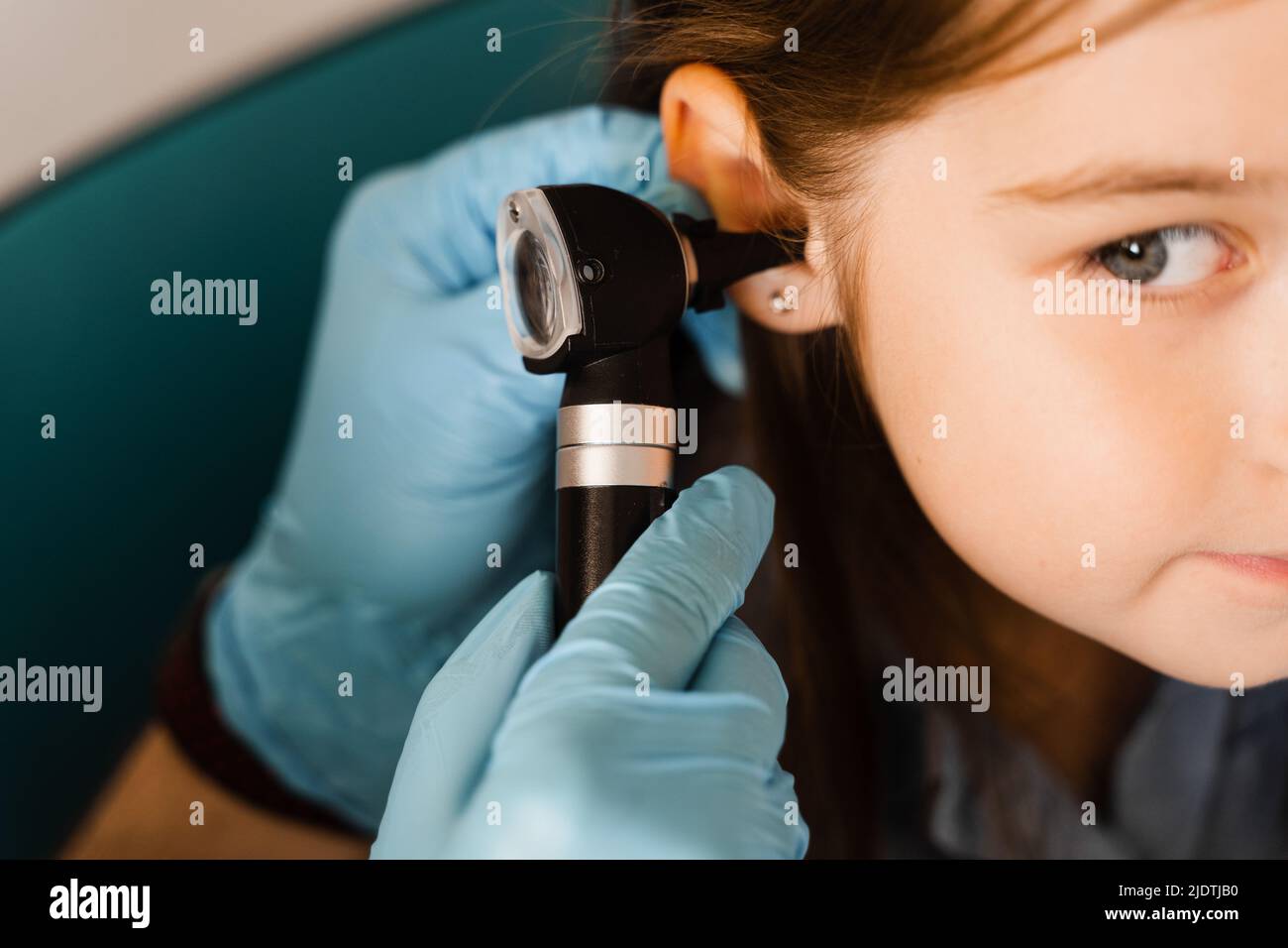 Close-up examination of childs ear with otoscope. Otoscopy. Visit to ...