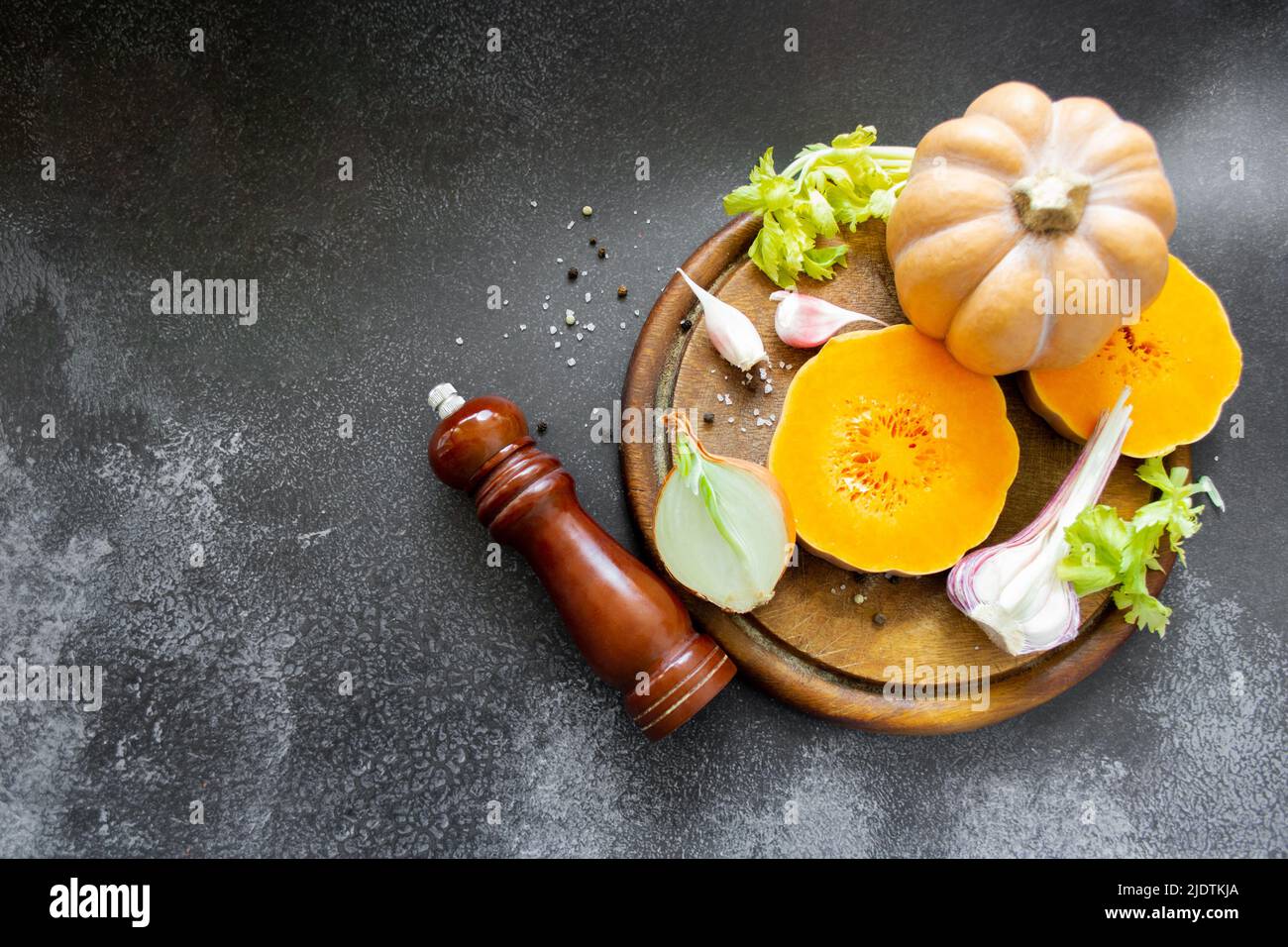 Vegetables: orange squash, garlic and onions. Spice mill, pepper with ...