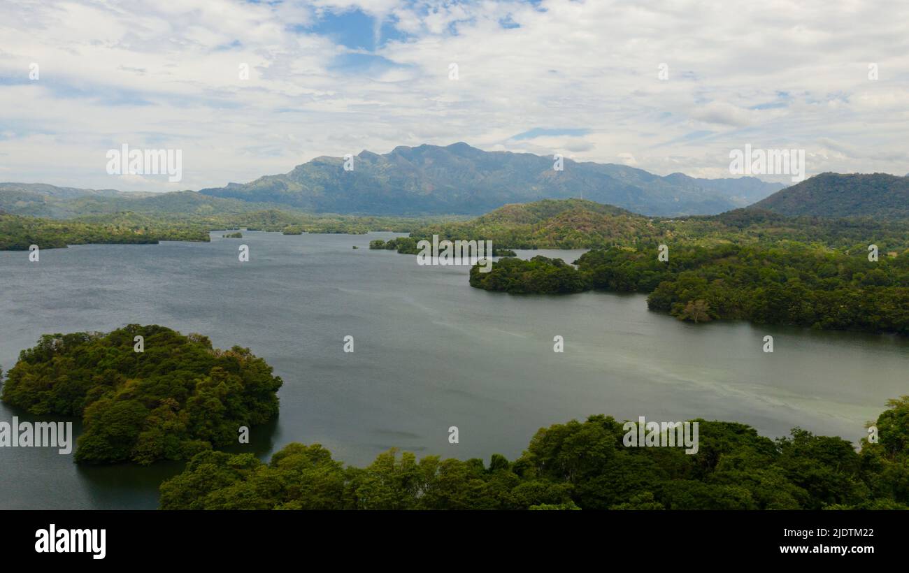 Aerial view of lake with islands surrounded by mountains with a ...