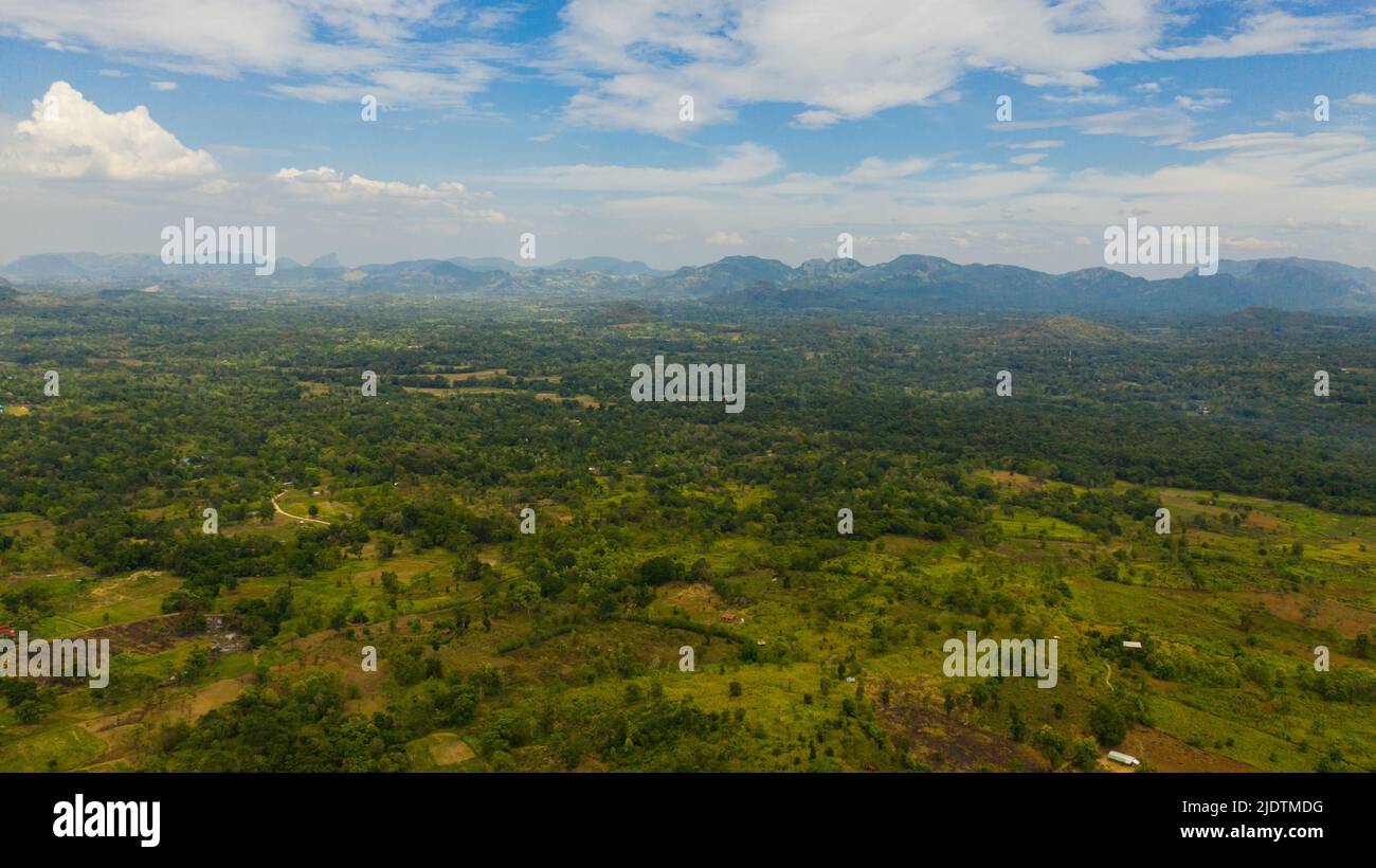 Aerial drone of Farmlands and villages in a valley among tropical ...