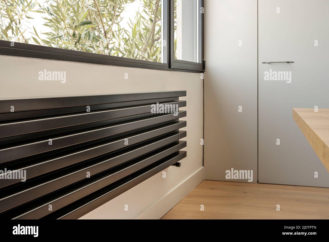 Detail of a modern black radiator under the window of a kitchen Stock ...
