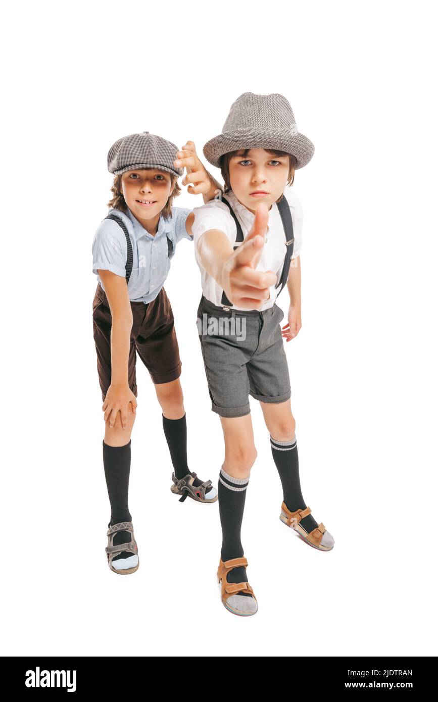 Serious little boys, stylish kids wearing retro clothes posing isolated ...