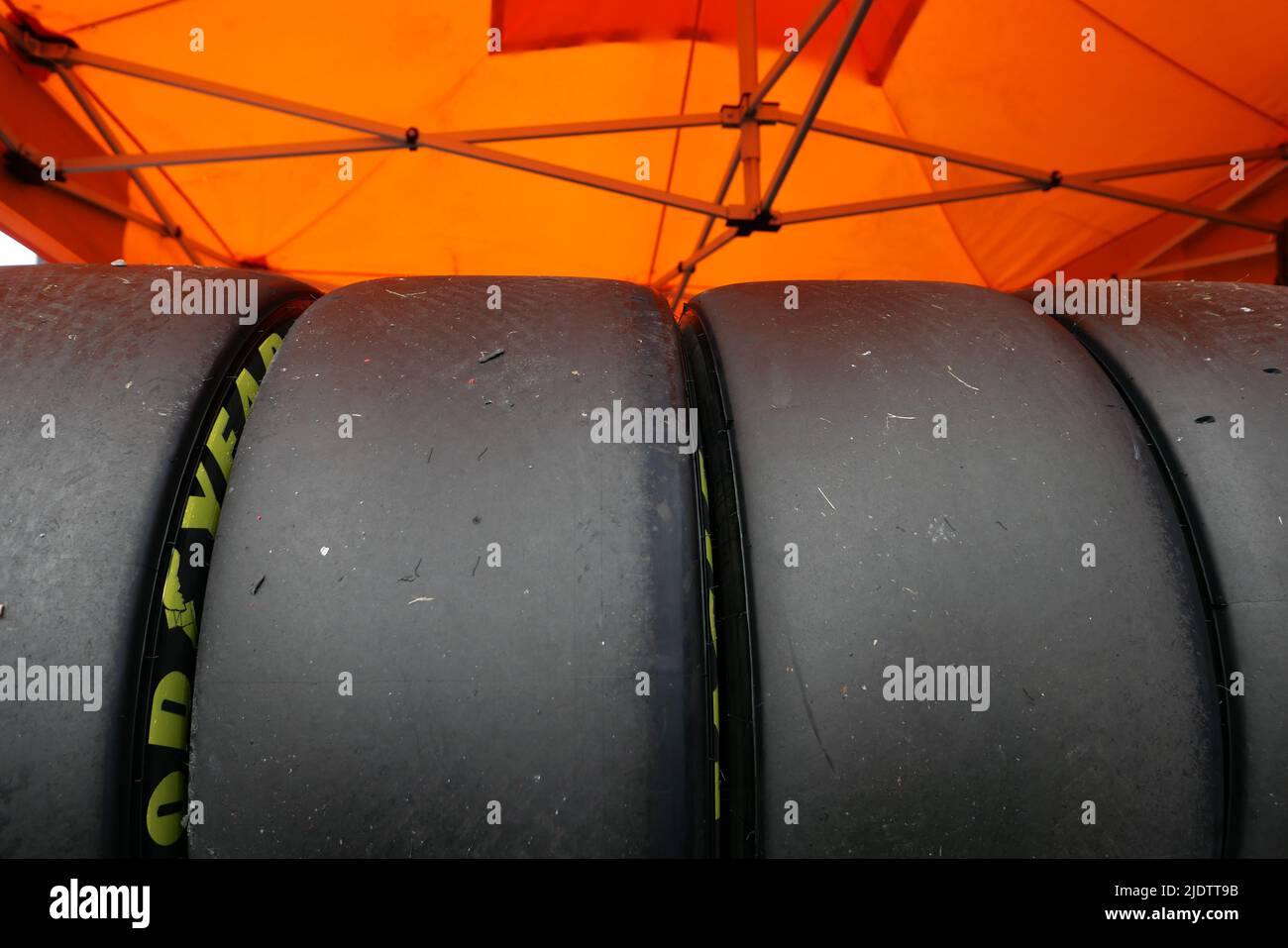 4 slick goodyear racing car tyres under an orange awning Stock Photo ...