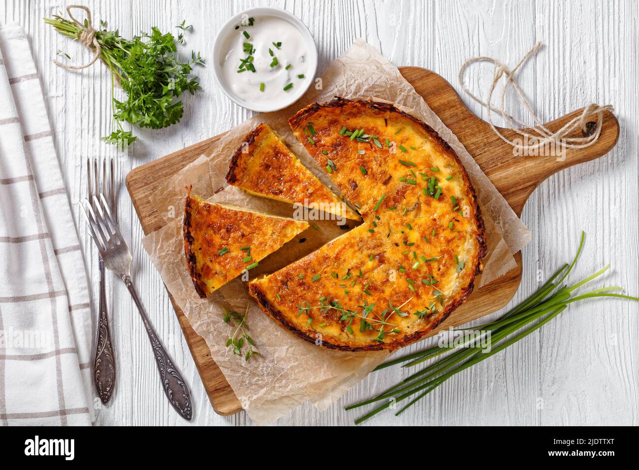 bacon and cheddar cheese quiche with hash brown crust on wood cutting ...