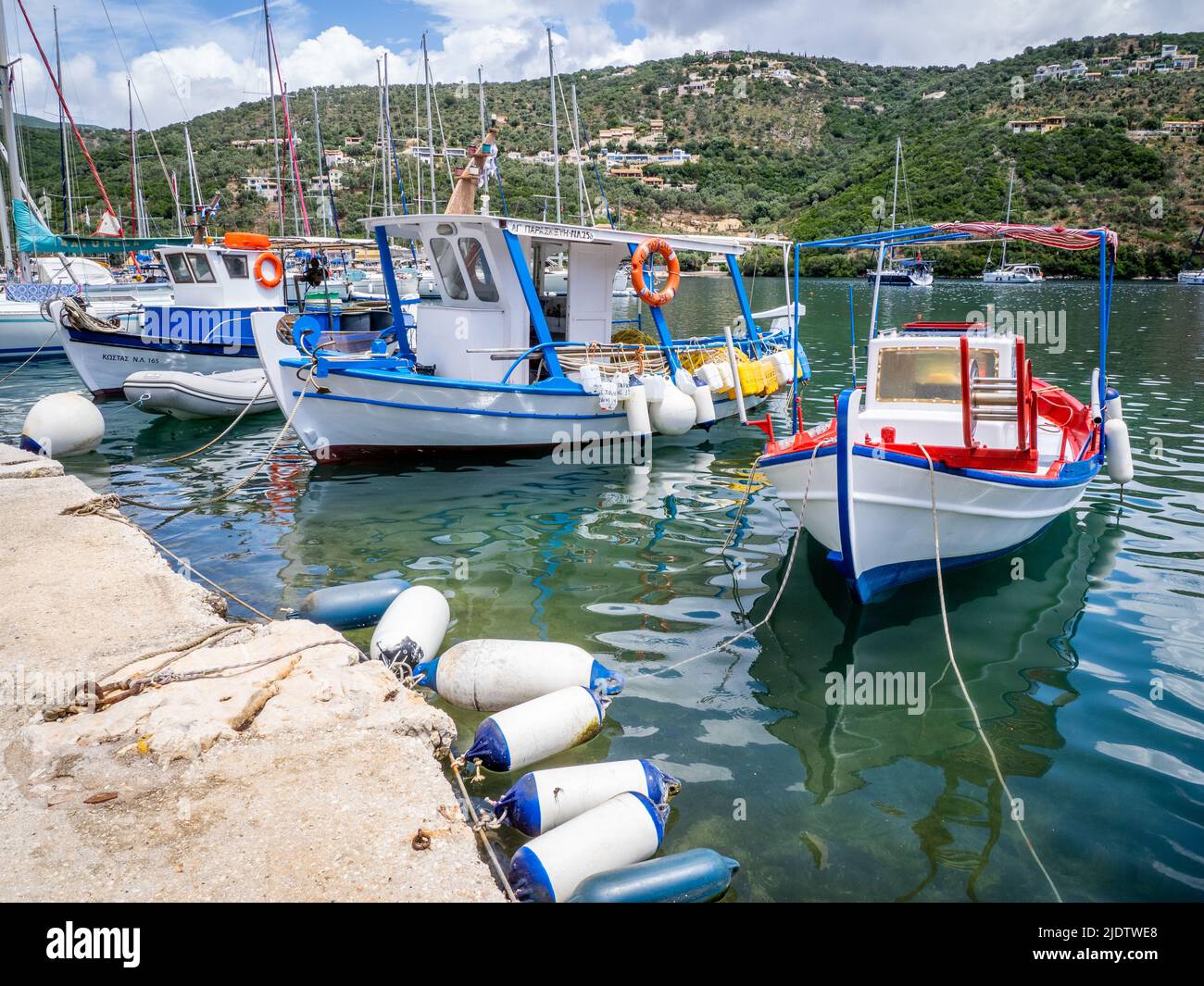 Boats in the pretty sheltered harbour of Sivota on the rugged south ...