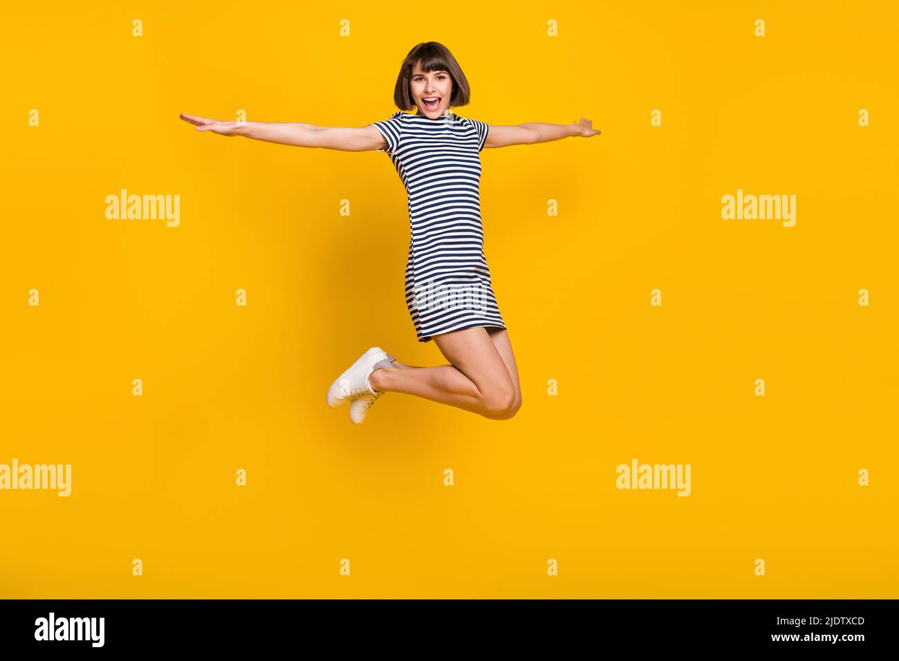 Full length photo of cool brunette young lady jump wear dress sneakers ...