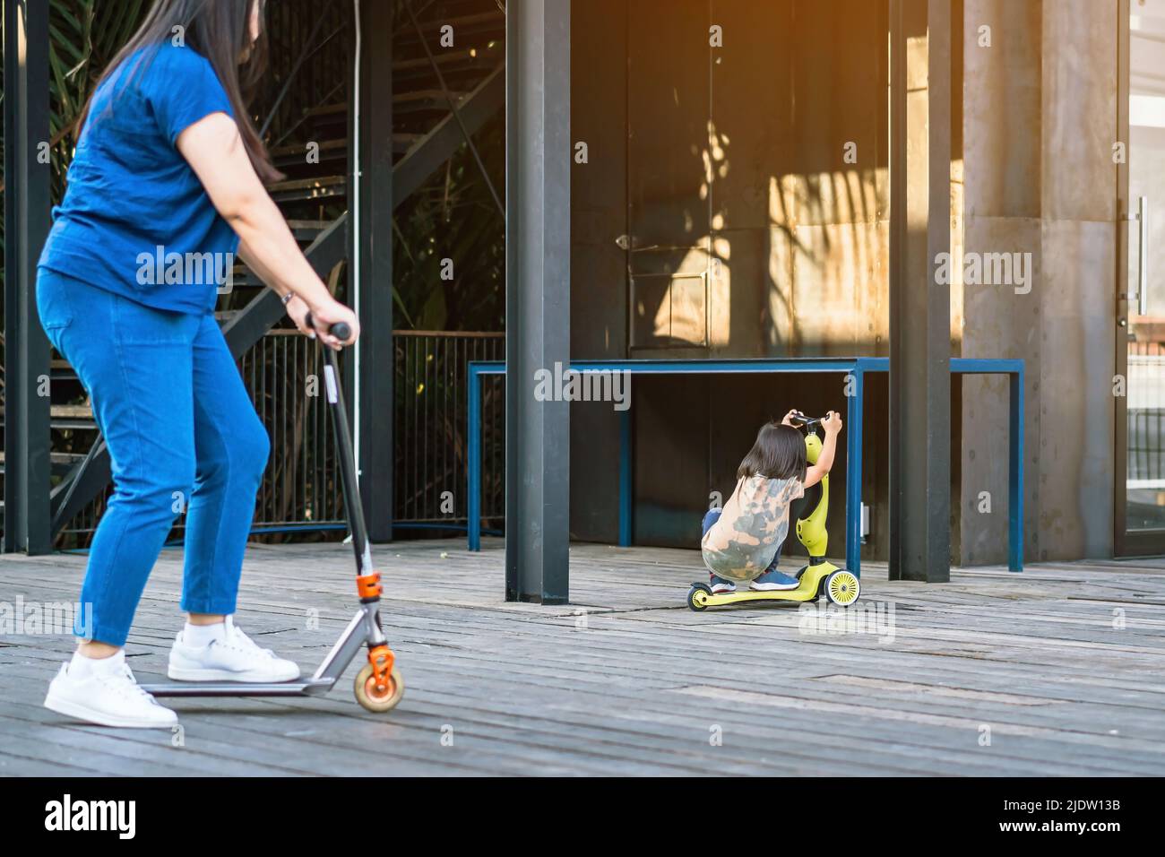 Asian kid enjoy playing and riding scooter without using any safety ...
