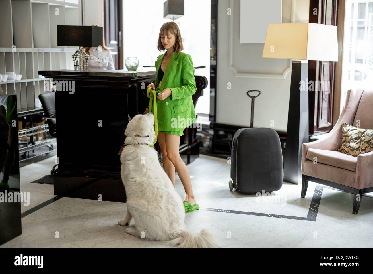 Business woman with her dog at hotel reception Stock Photo - Alamy