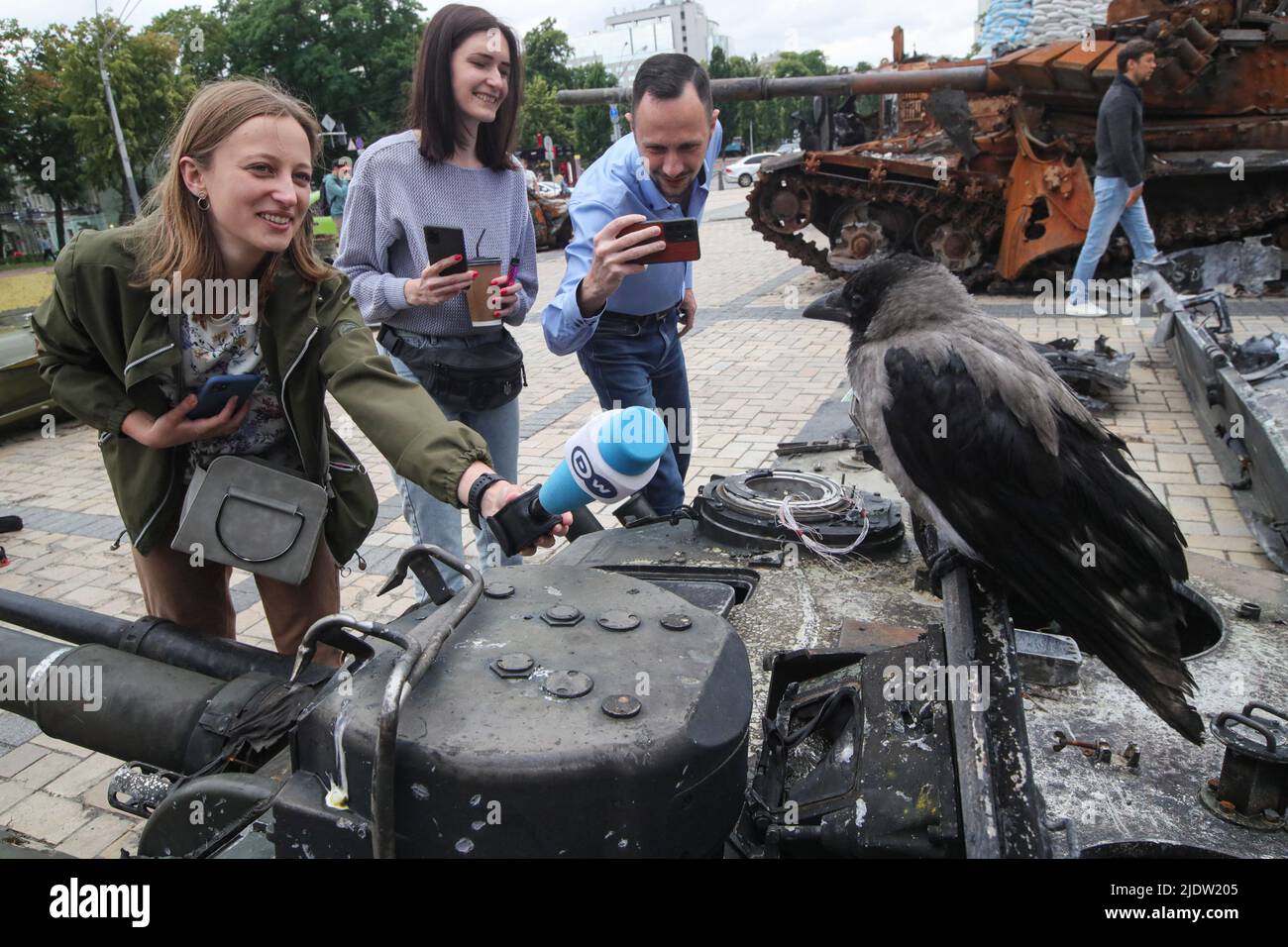 Kyiv, Ukraine. June 23, 2022, People look at a crow perched on one of ...