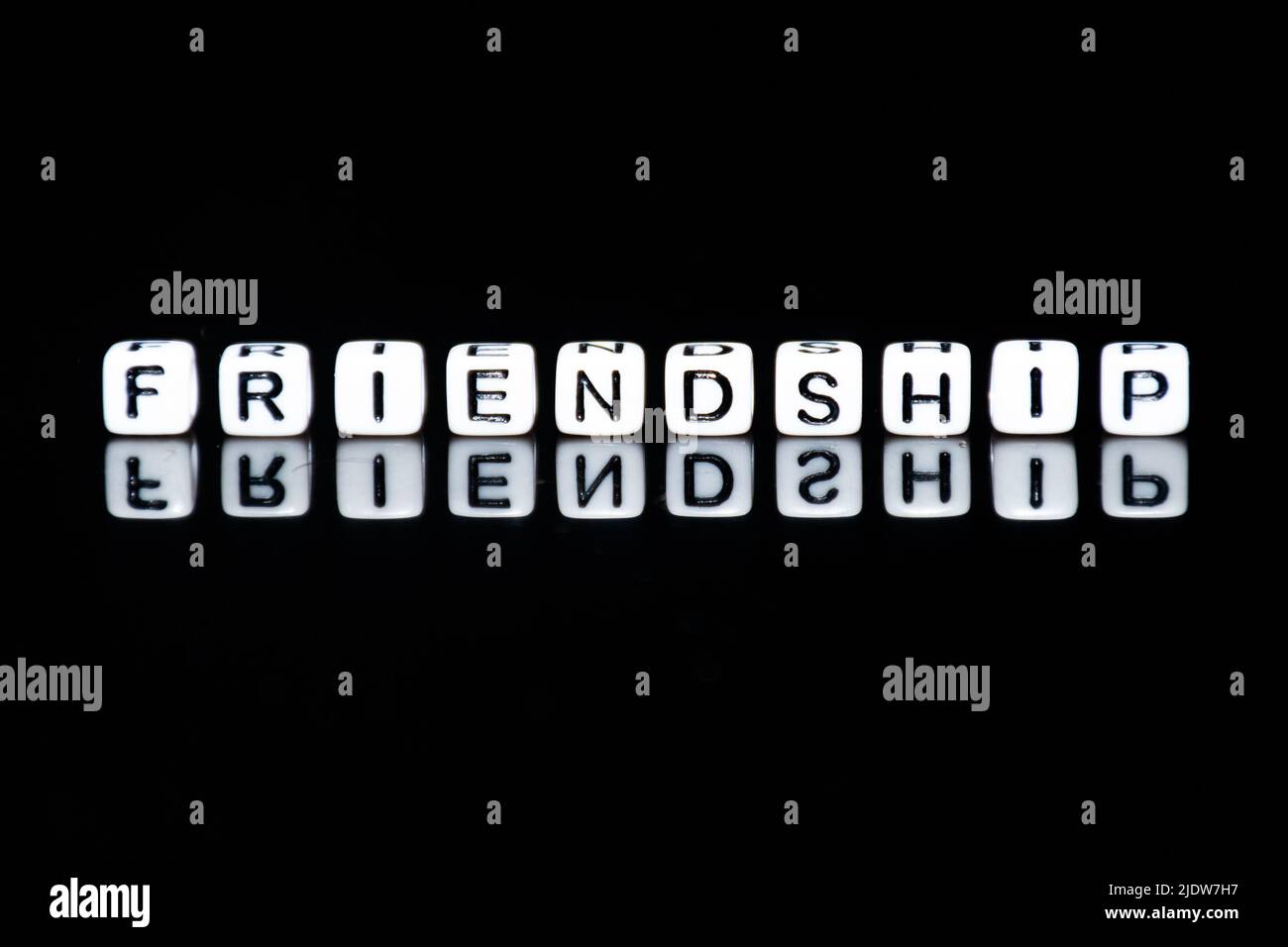 The word of "FRIENDSHIP" making from little acrylic cubes in black ...