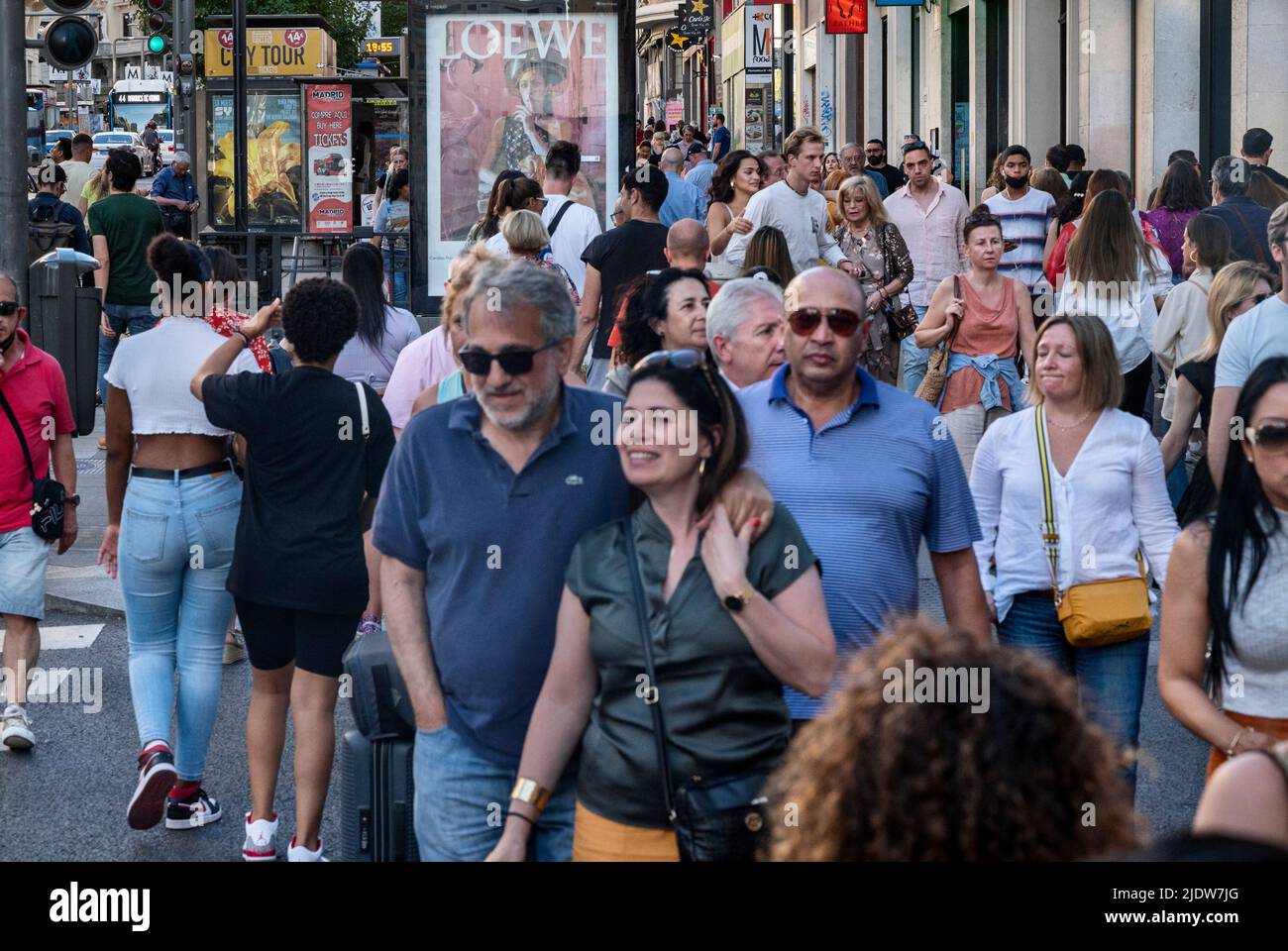 Pedestrians walk past a street commercial ad from the Spanish luxury ...