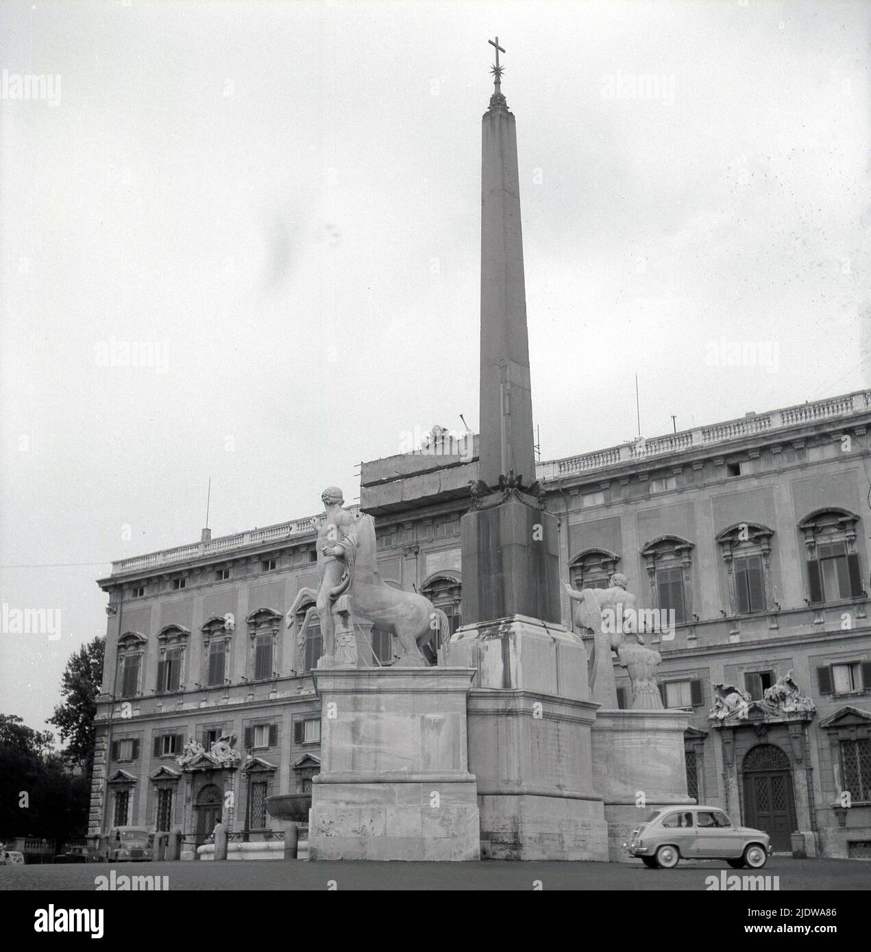 1950s, historical, tall stone column with religious, christian cross on ...