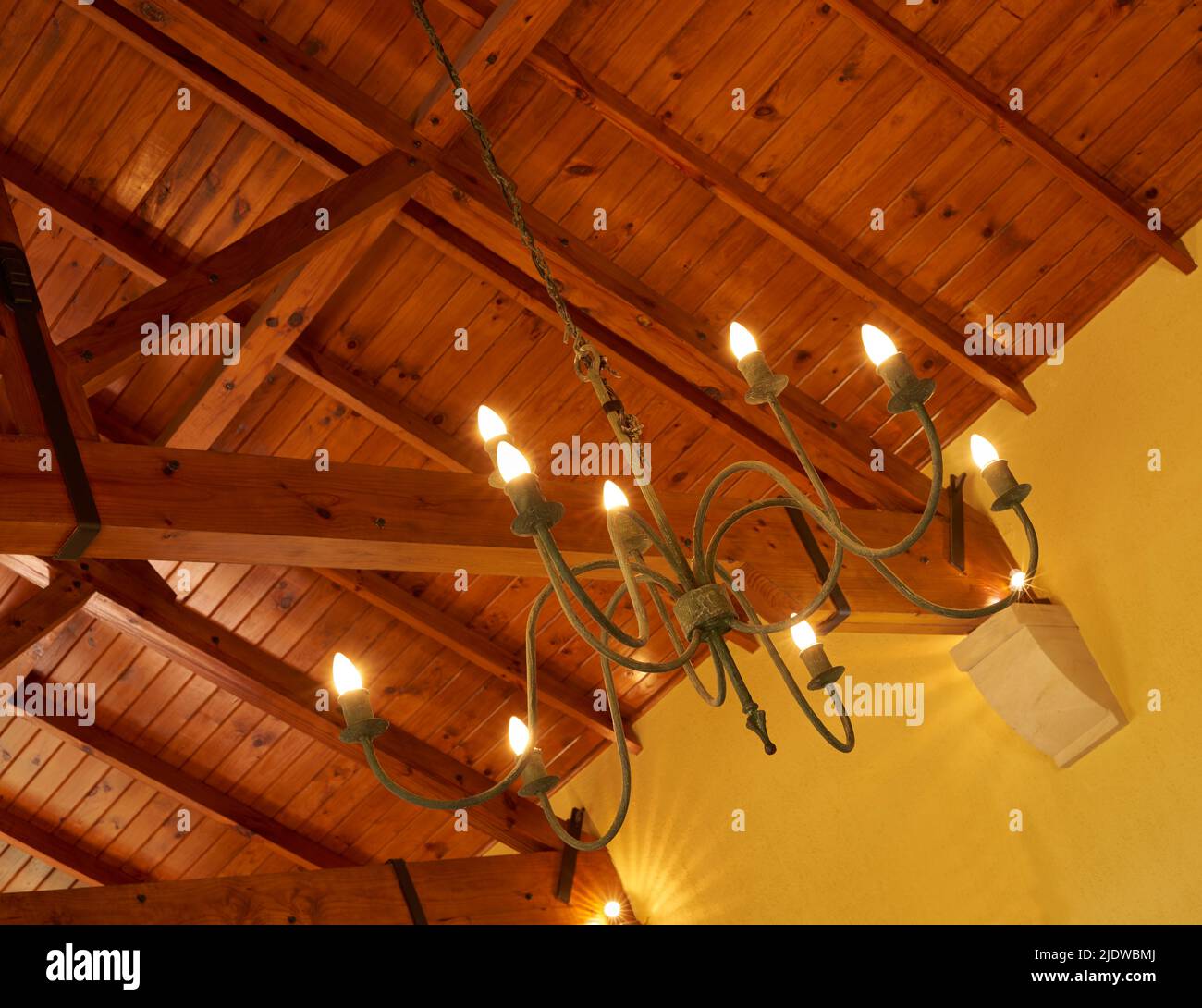 Below view of an old fashioned chandelier with candle lightbulbs ...