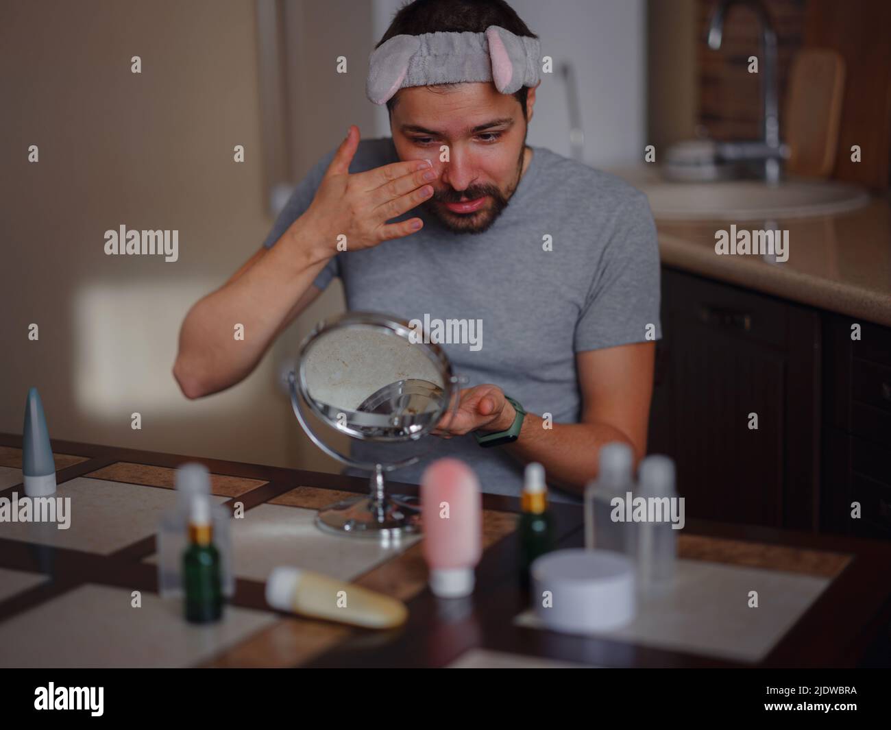 Men's beauty concept. caucAsian guy checking his skin. man looking into ...