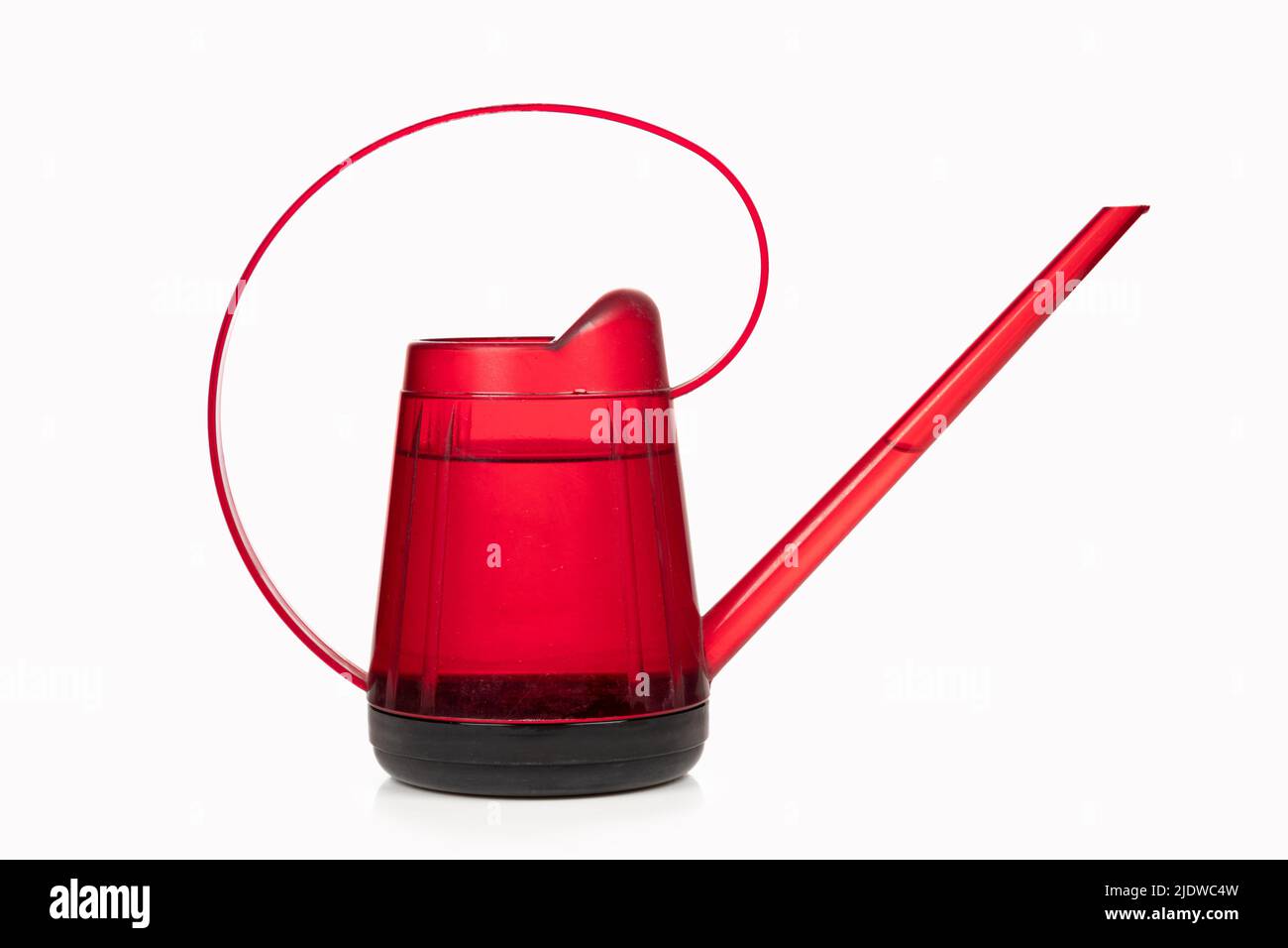 Red plastic watering can isolated on white background Stock Photo - Alamy