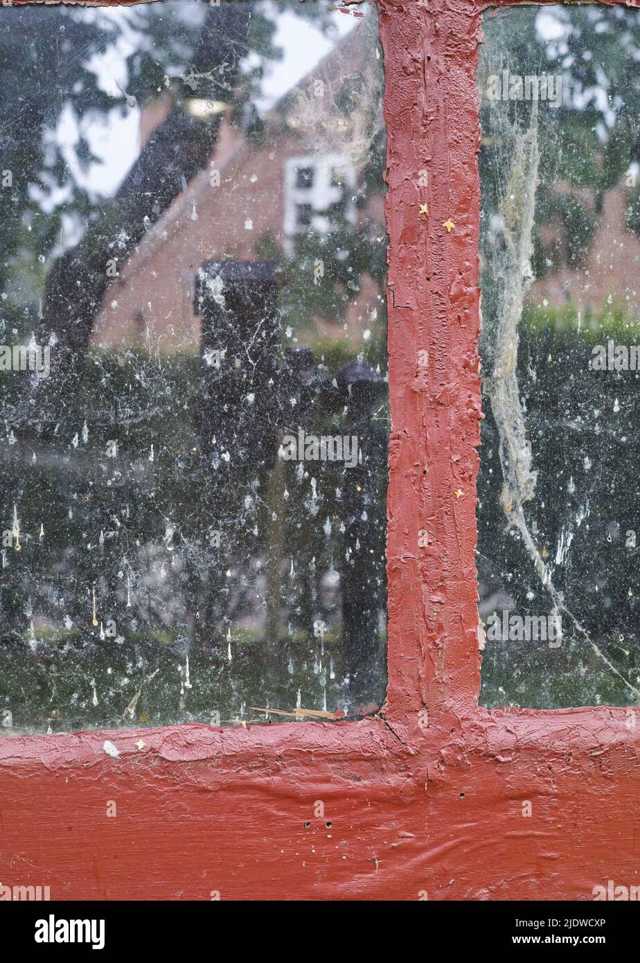 Closeup of an old dirty window looking out into the neighborhood ...