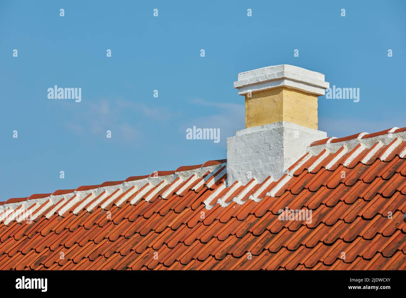 Brick chimney designed on slate roof of house building outside against ...