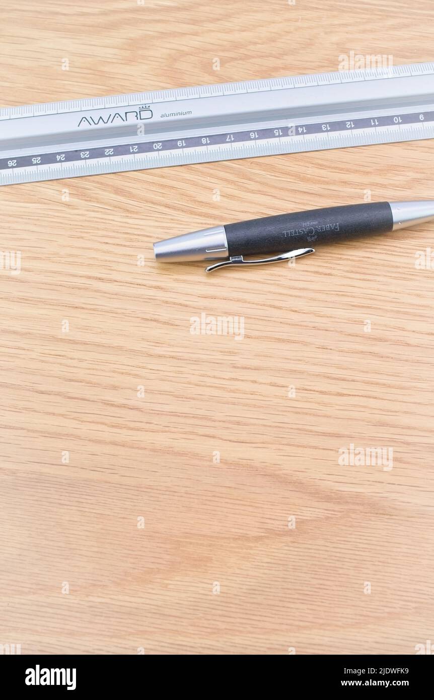 metal decimal ruler and pencil on a wooden desk Stock Photo - Alamy