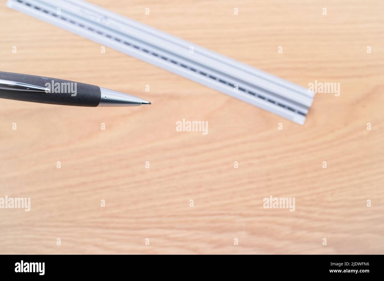 metal decimal ruler and pencil on a wooden desk Stock Photo - Alamy
