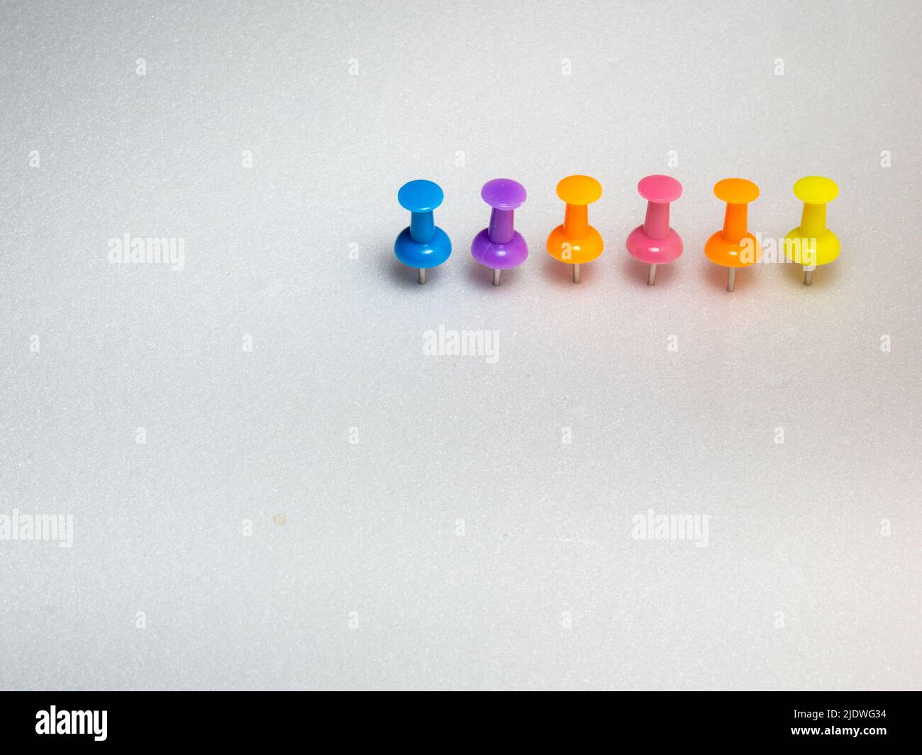 colored memothumb tacks. Stationery on white background. necessary for ...