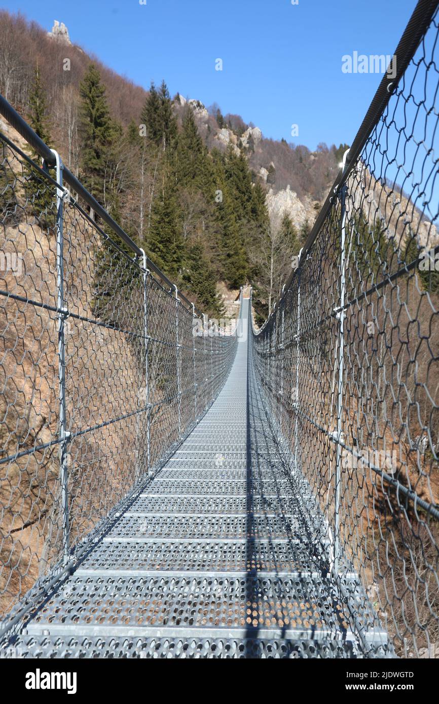 long suspension bridge made of sturdy steel ropes and metal sleepers ...