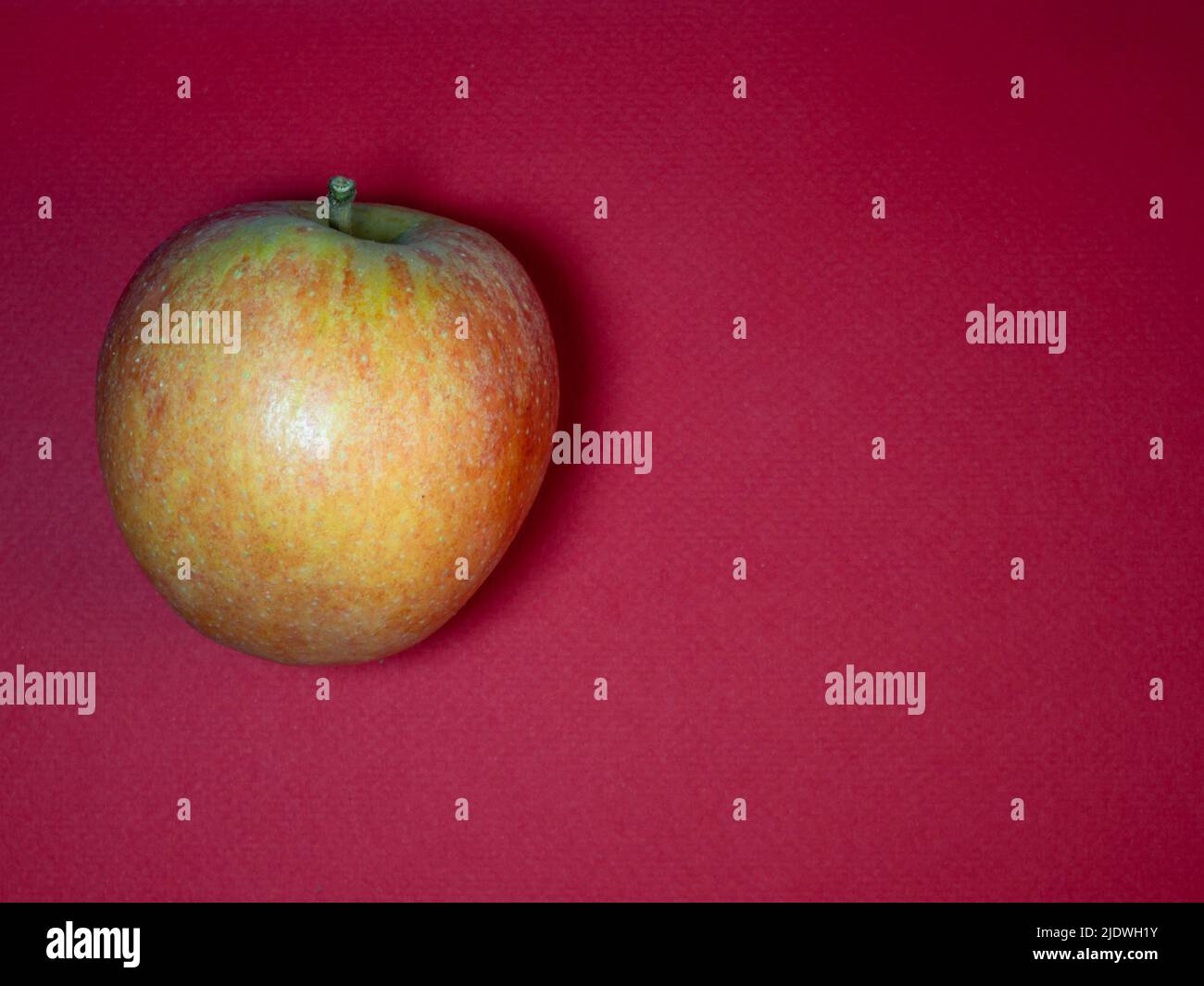 Big red apple on a purple background.The product is on the table. Fresh ...