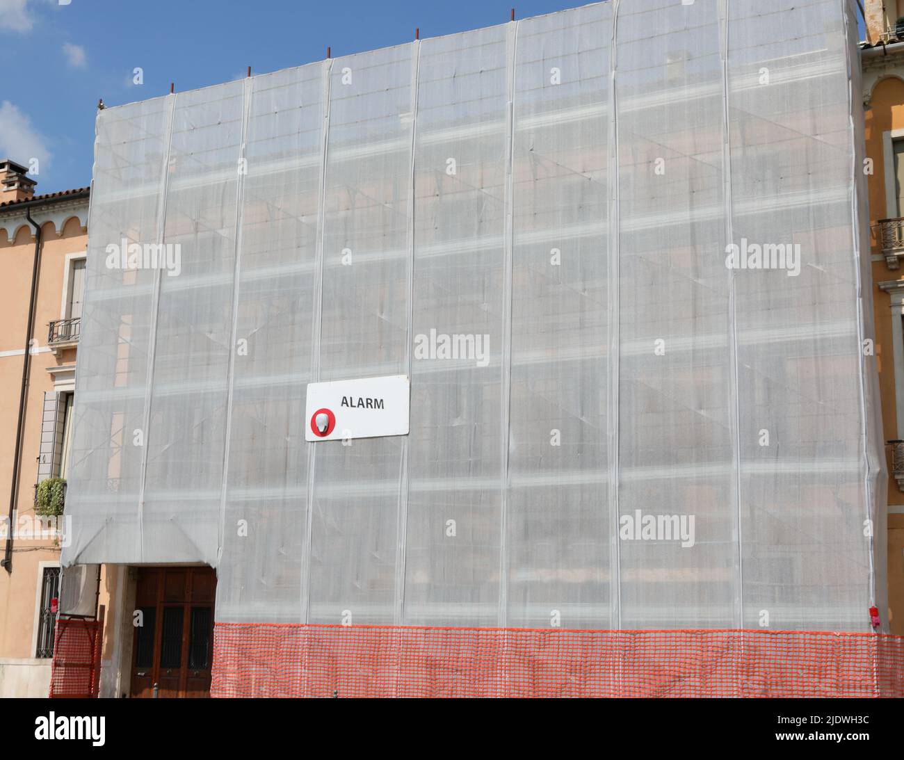 construction site with the house completely covered with scaffolding ...