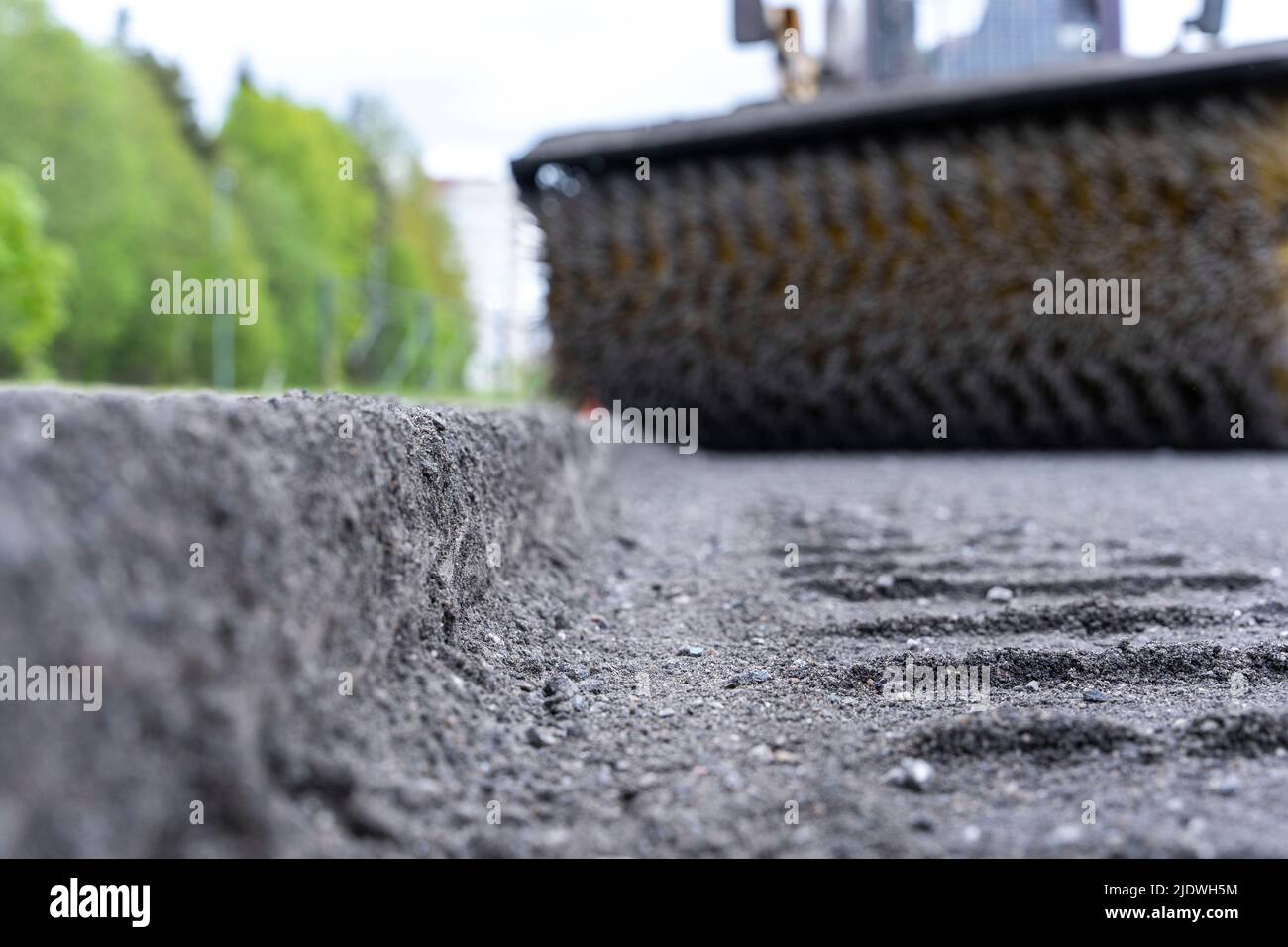 Cleaning of garbage from the road. a rotating mechanical machine brush ...