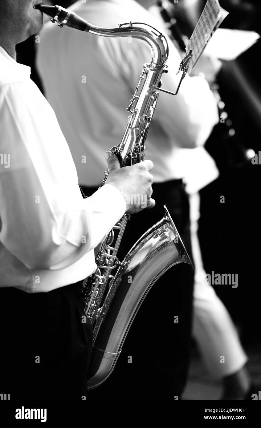 sax player while playing the instrument in the marching band during a ...