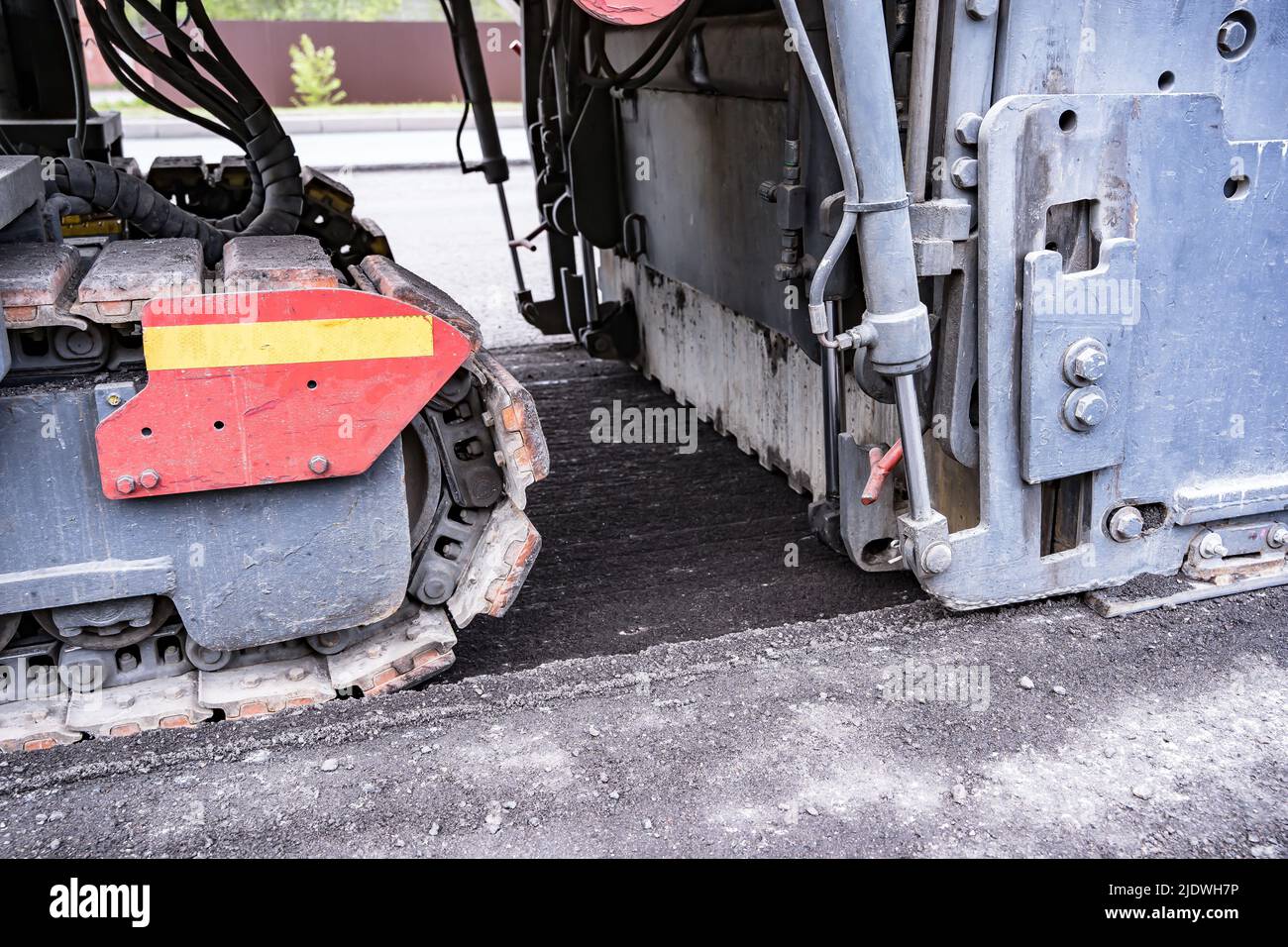Large Road cold milling machine removes the old asphalt and loading ...