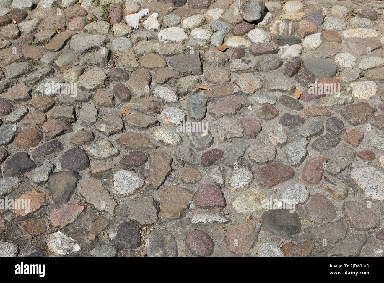 road pavement background made of pebbles and stones of various sizes ...