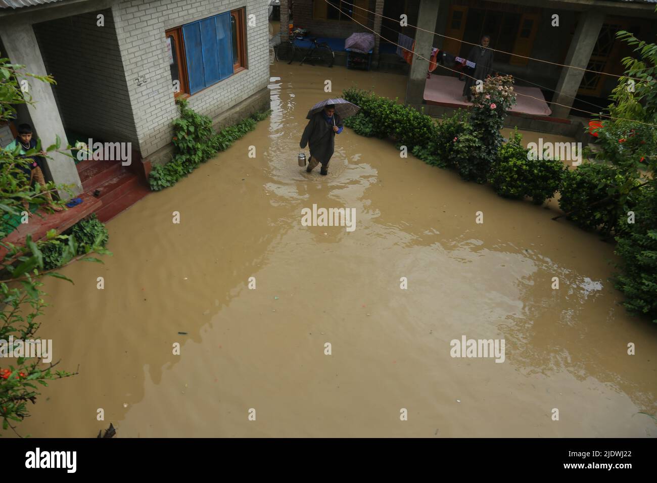 Flood water flows through the residential area after incessant rainfall ...