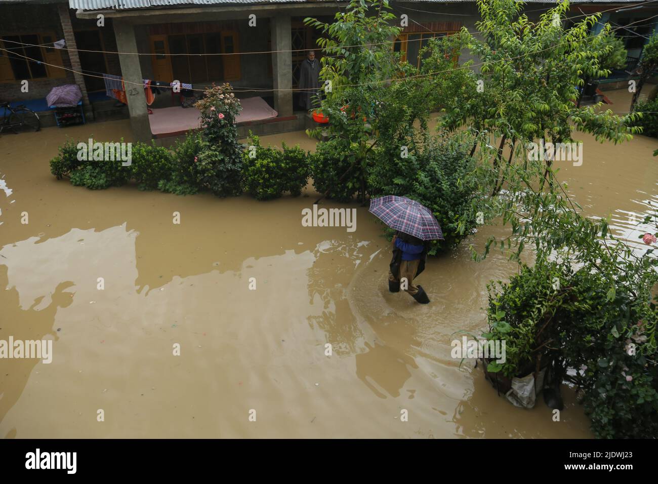 Srinagar, India. 22nd June, 2022. Flood water flows through the ...