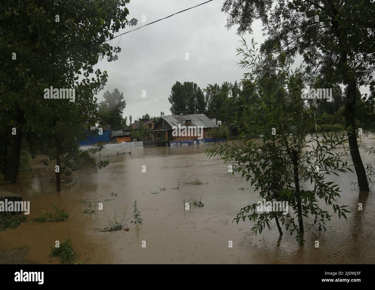 Srinagar, India. 22nd June, 2022. Flood water flows through the ...