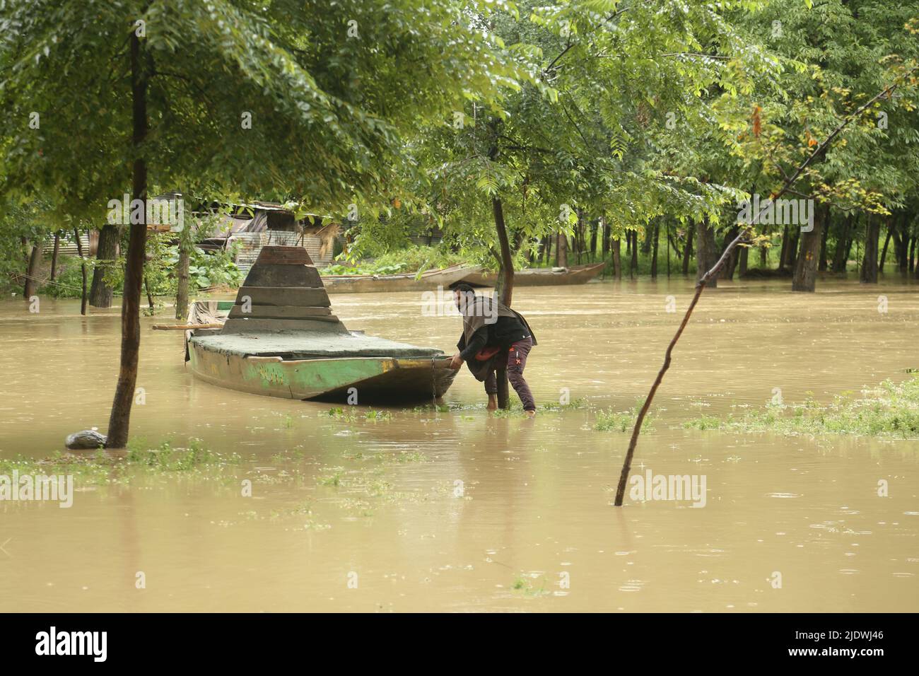 Srinagar, India. 22nd June, 2022. Flood water flows through the ...