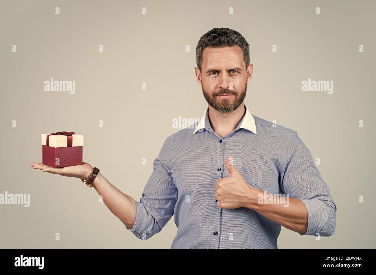 mature confident man businessman in shirt presenting gift box and ...