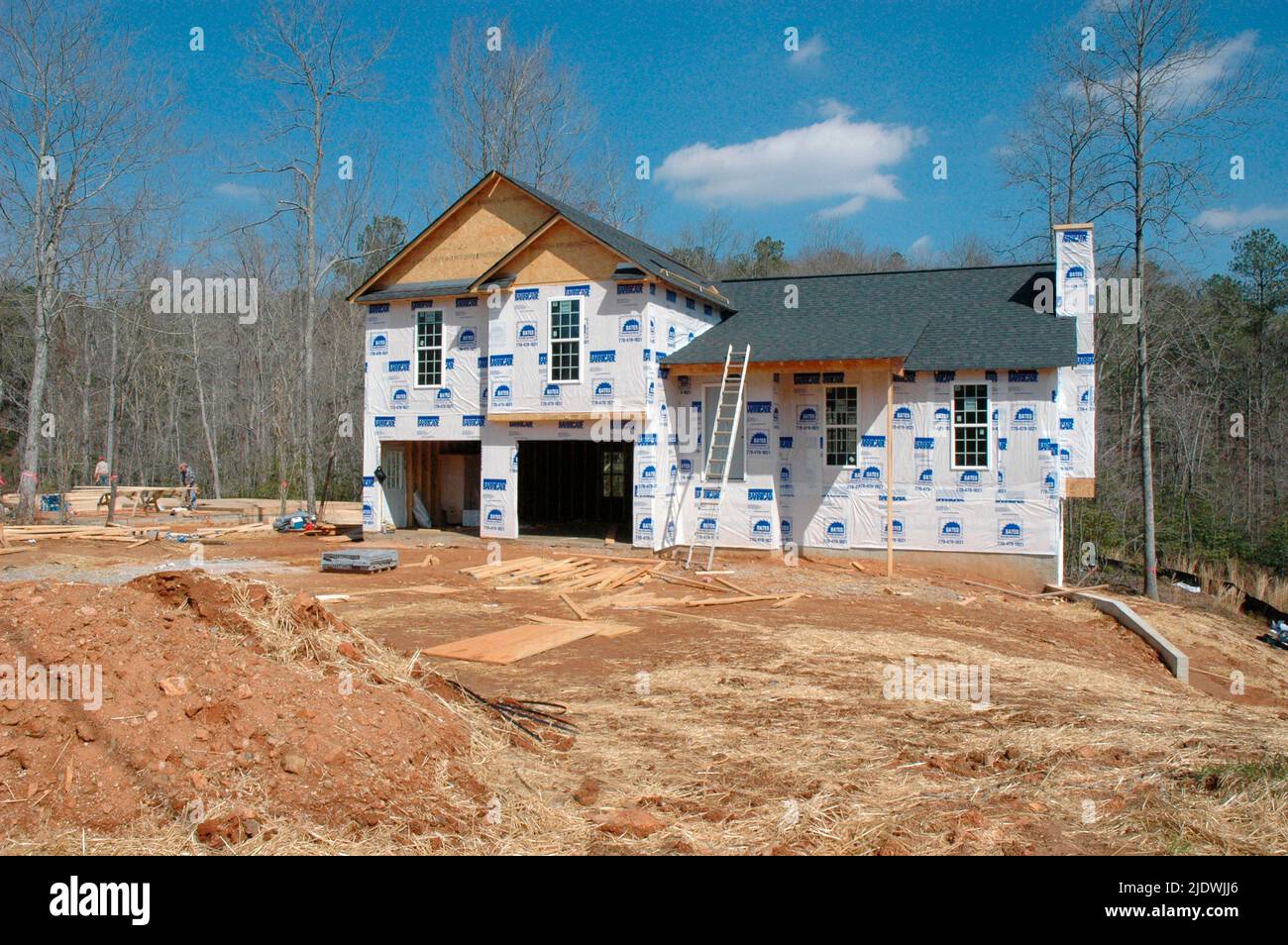 New house with tyvek and before siding is added on stripped lot without ...