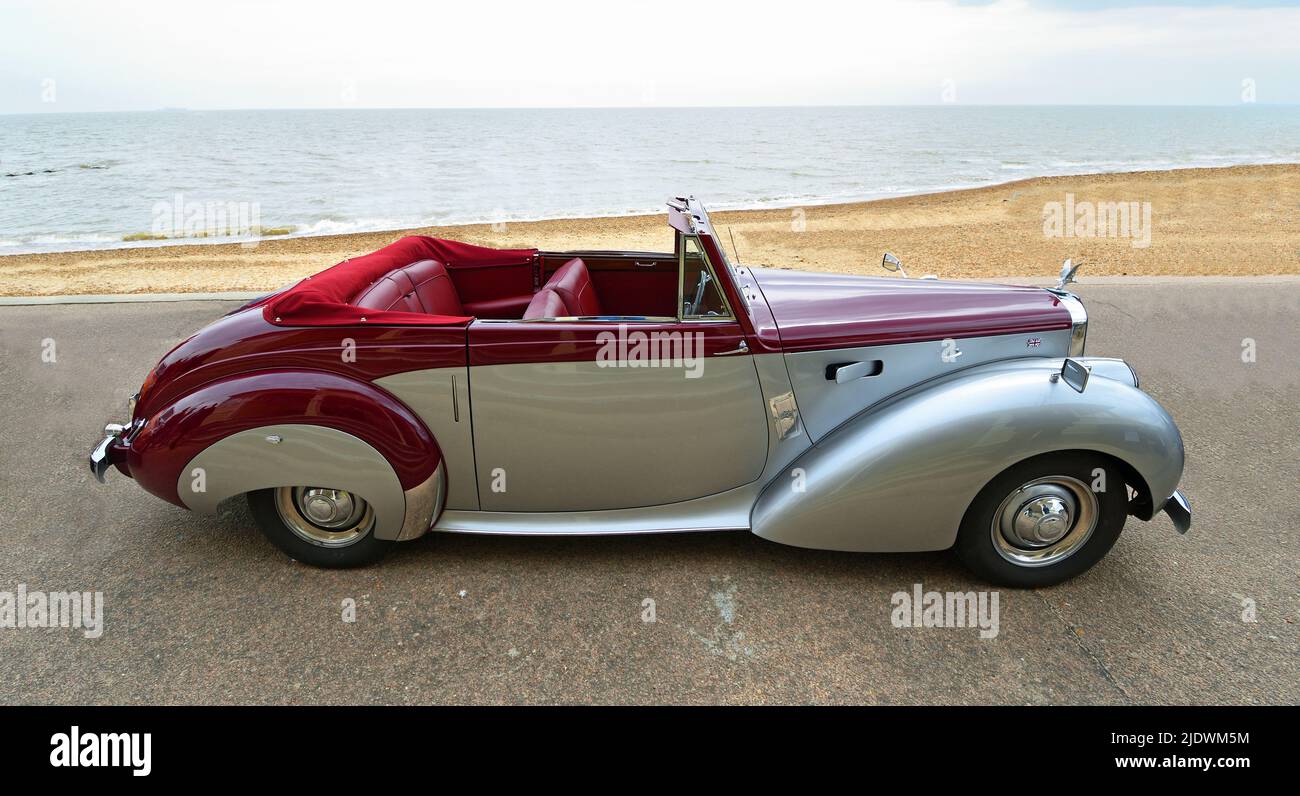 Classic Alvis convertible car parked on seafront promenade beach and ...