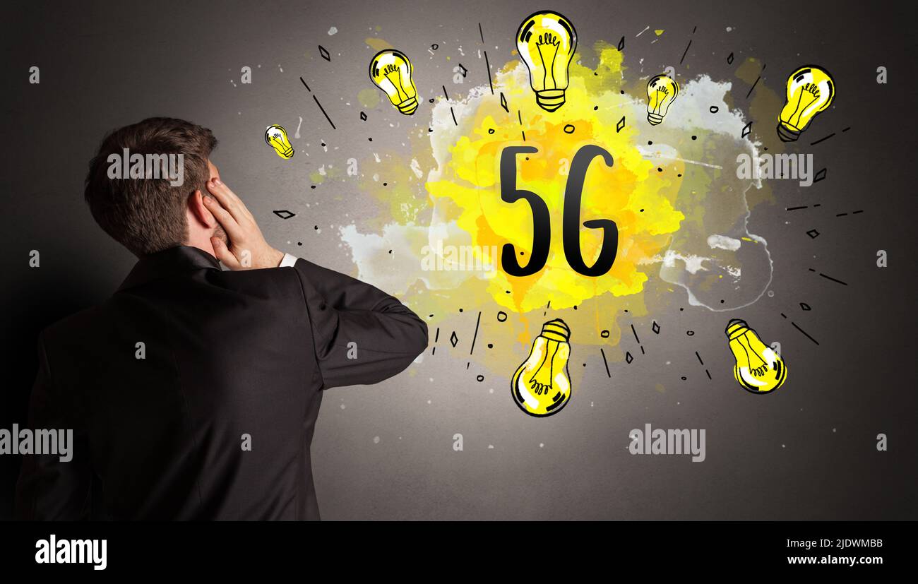 man drawing colorful light bulb Stock Photo - Alamy