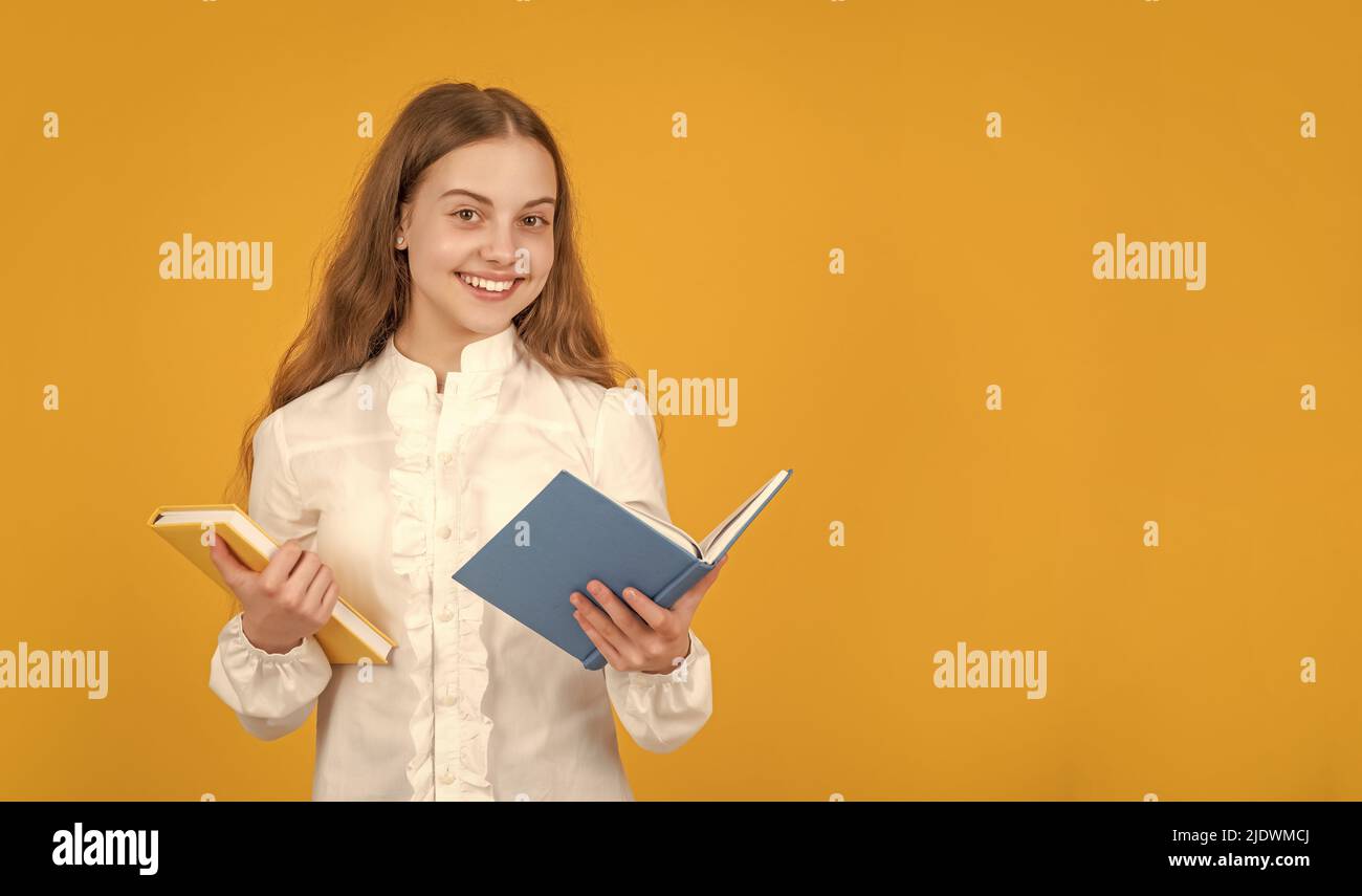 happy child ready to study do homework read book on yellow background ...