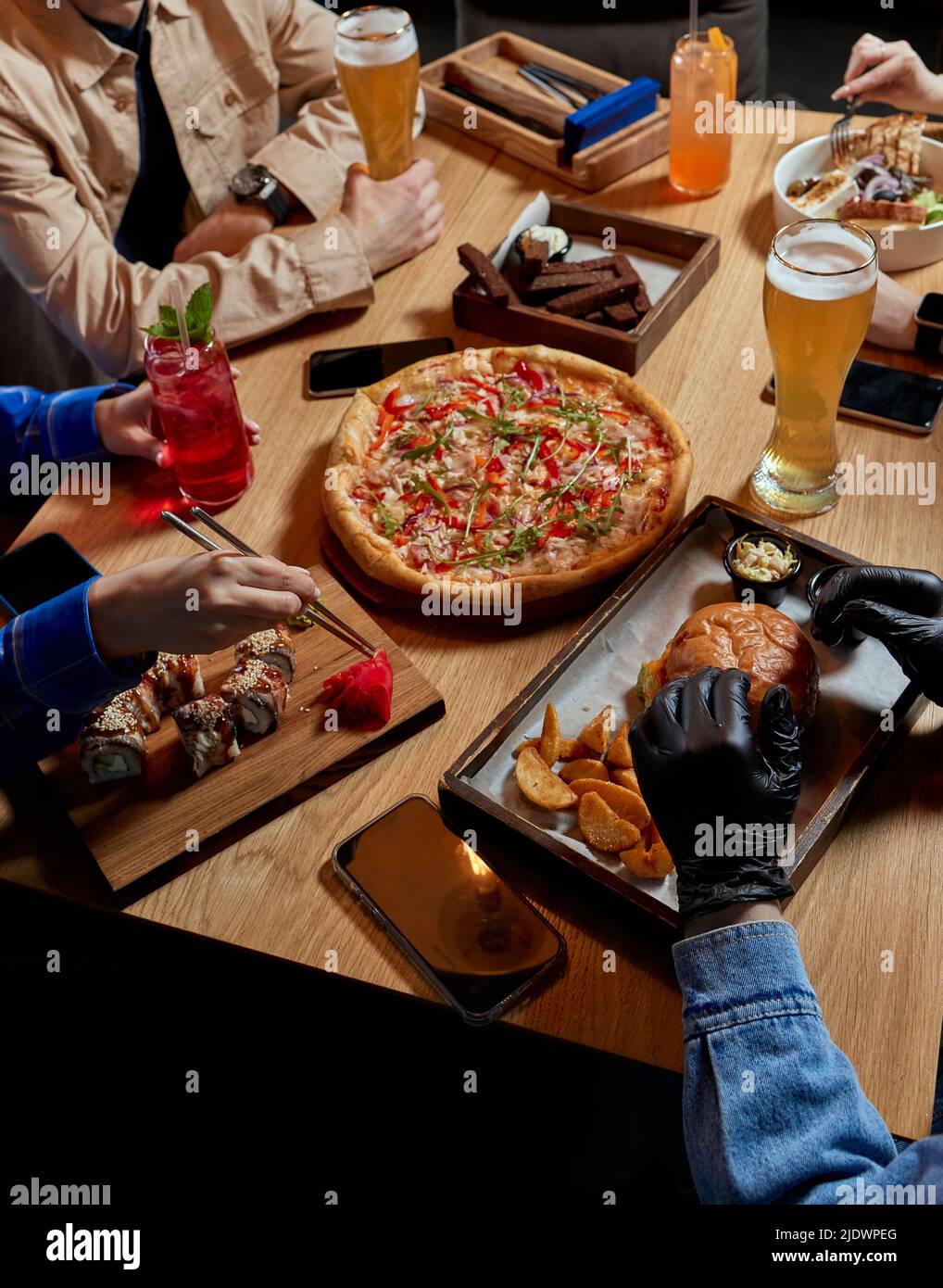 Enjoying dinner with friends. Top view of group of people having dinner ...