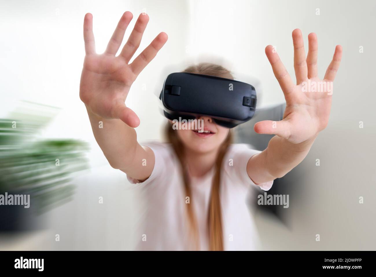 Teenage girl wearing virtual reality goggles headset and playing, vr box. technology with motion ...