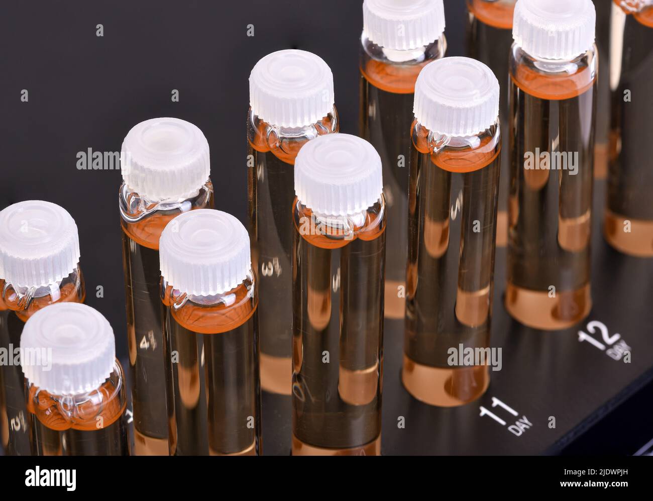 Glass vails with plastic caps on paper numbers plate Stock Photo - Alamy