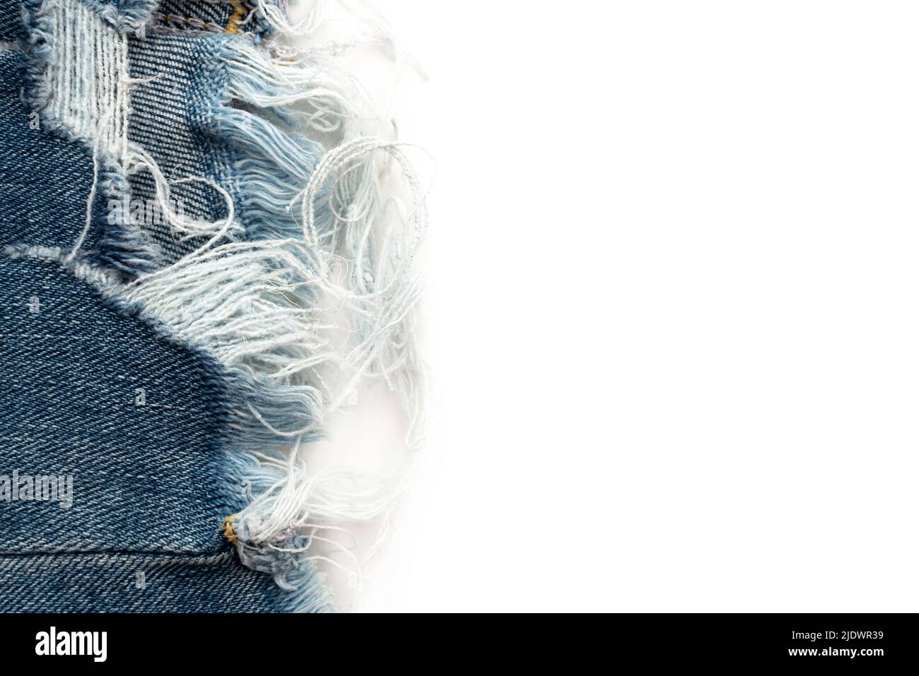 Frayed ripped jeans on a white background. Denim frame with empty space ...