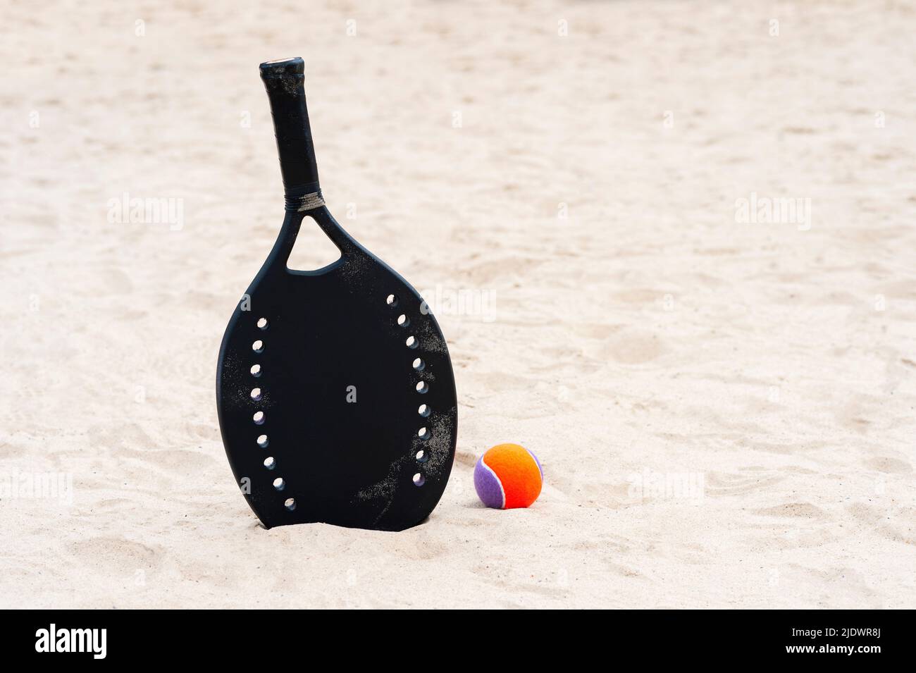 Racket and ball on the sandy beach. Summer sport concept. Horizontal ...