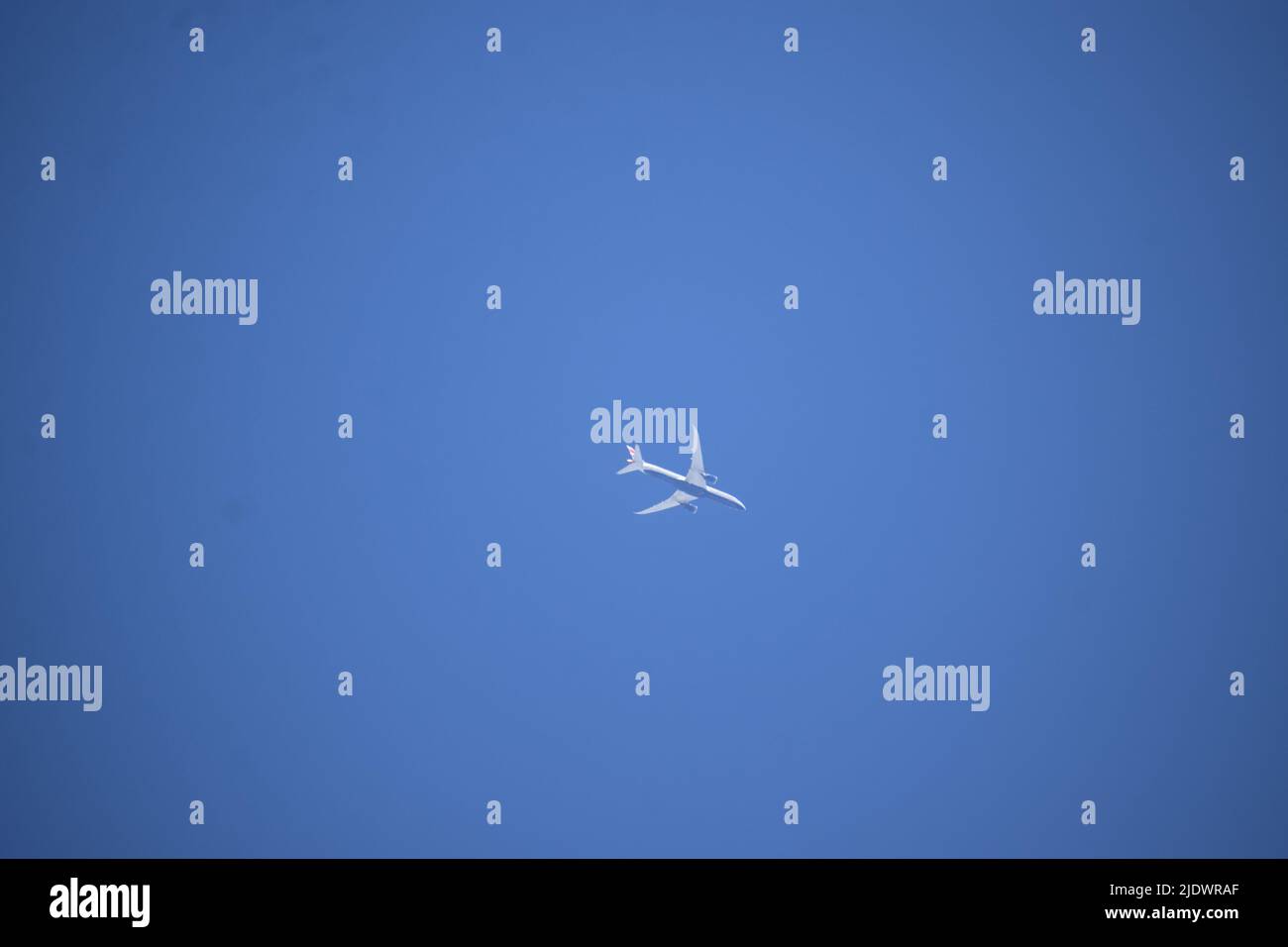 plane in blue sky Stock Photo - Alamy