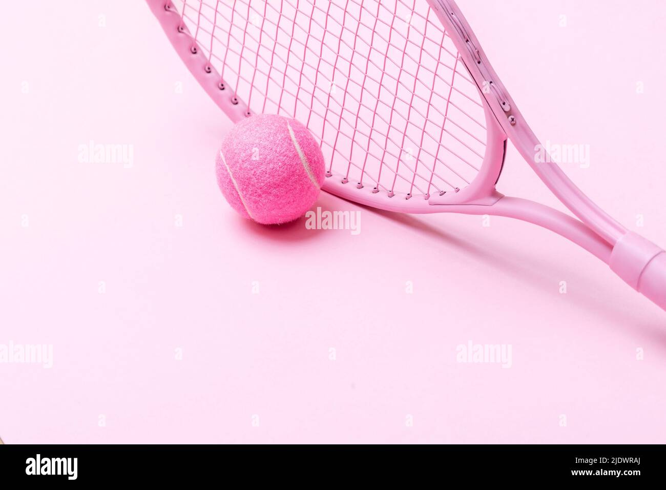 Pink tennis racket and pink ball on pink background. Horizontal sport ...