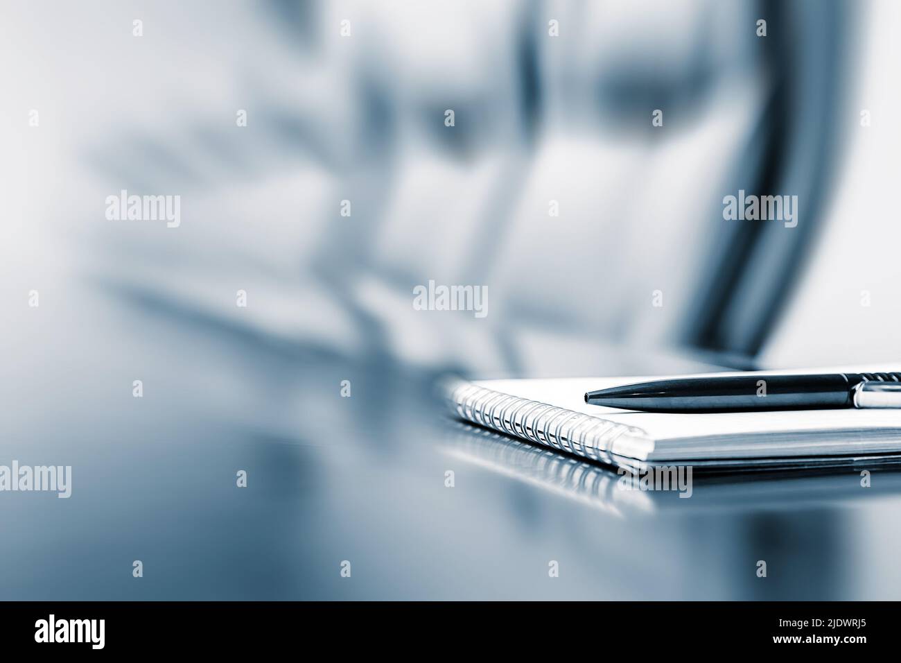 Closeup of notepad kept on table in empty room with motion blur effect ...